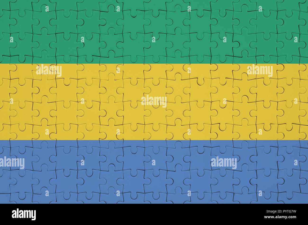 Gabon flag is depicted on a folded puzzle Stock Photo - Alamy