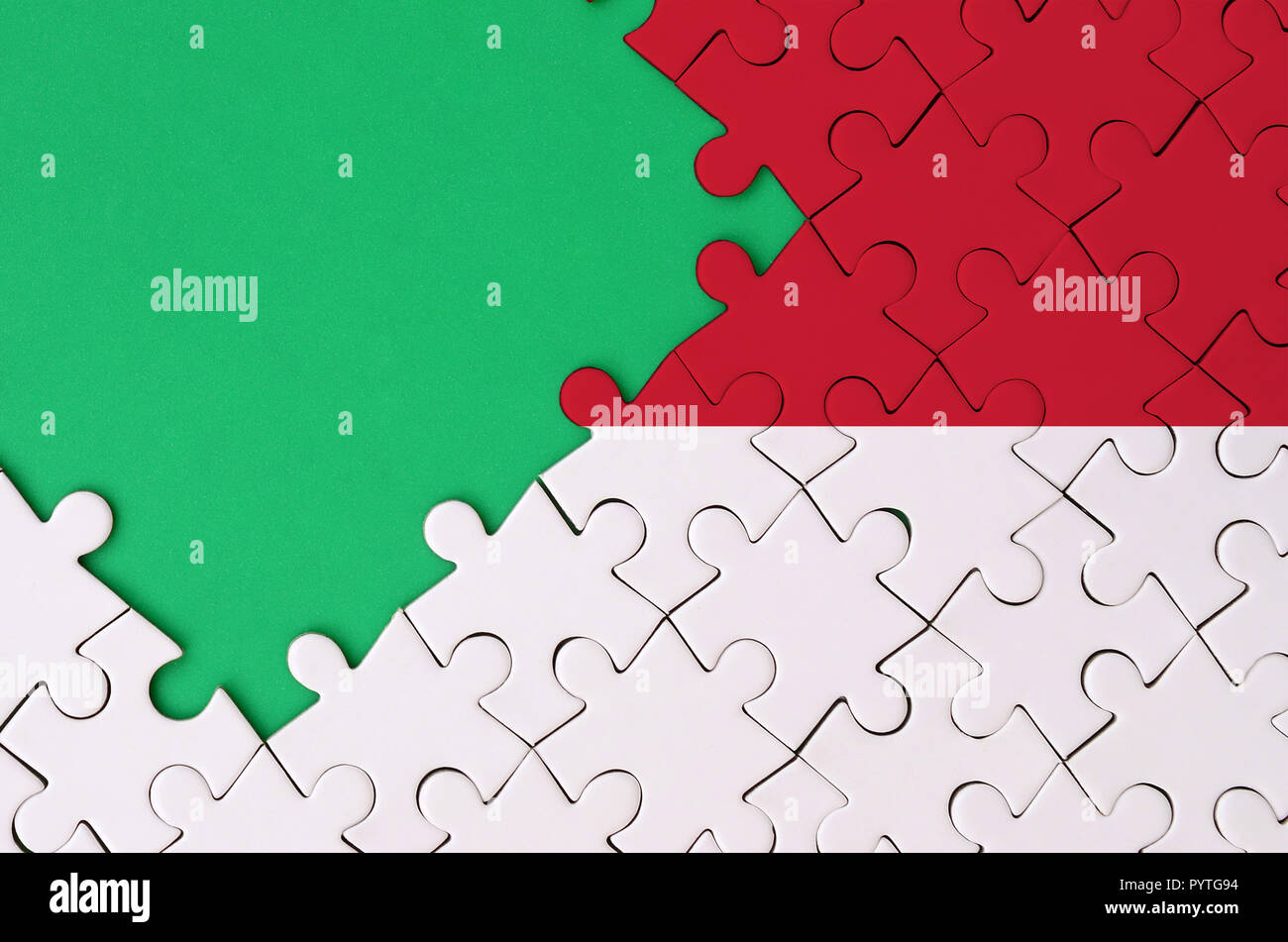 Indonesia flag is depicted on a completed jigsaw puzzle with free green ...