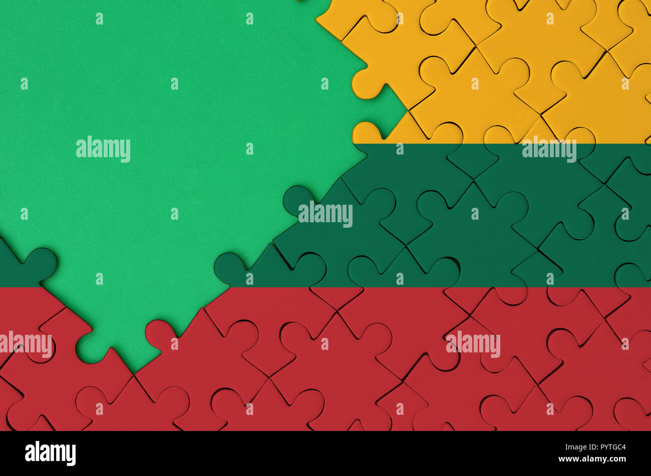 Lithuania flag is depicted on a completed jigsaw puzzle with free green ...