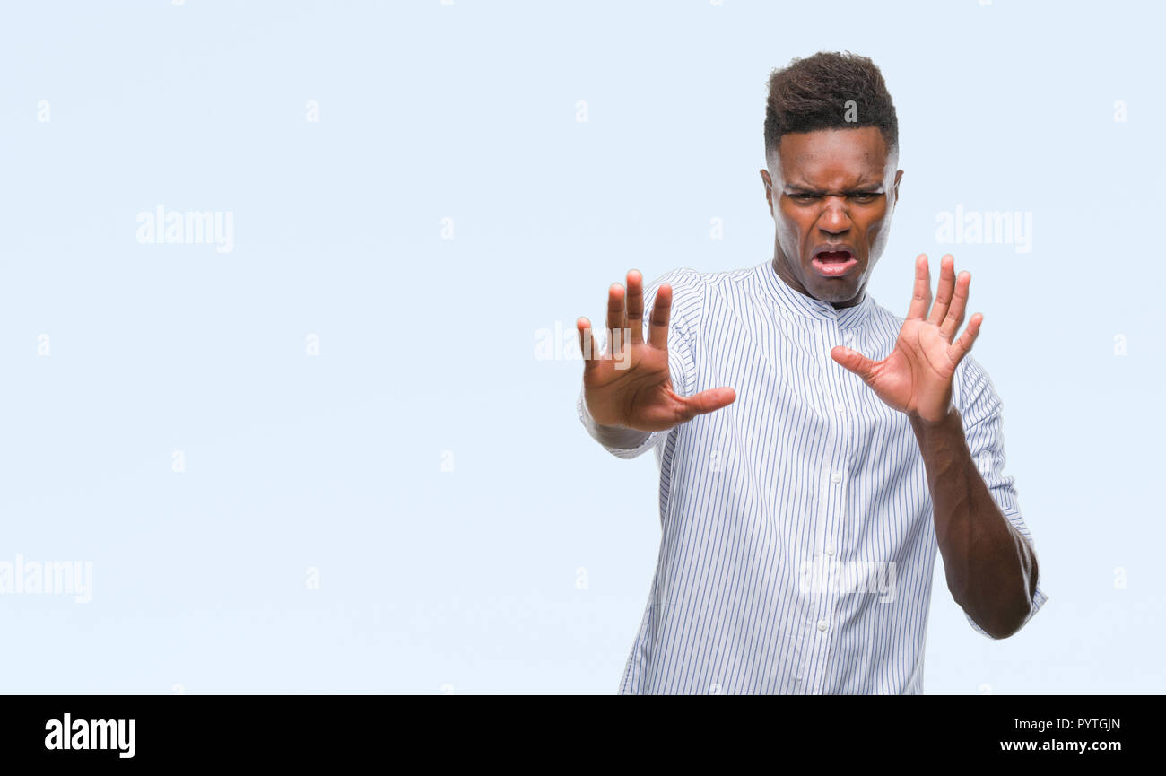Young african american man over isolated background afraid and ...