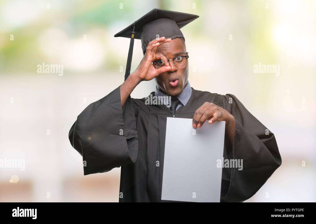 Young graduated african american man holding blank paper degree over ...