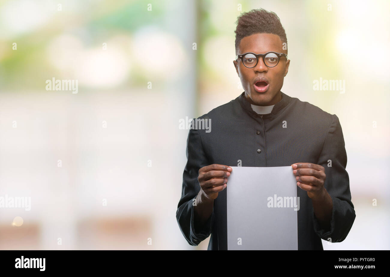 Young african american priest man over isolated background holding ...