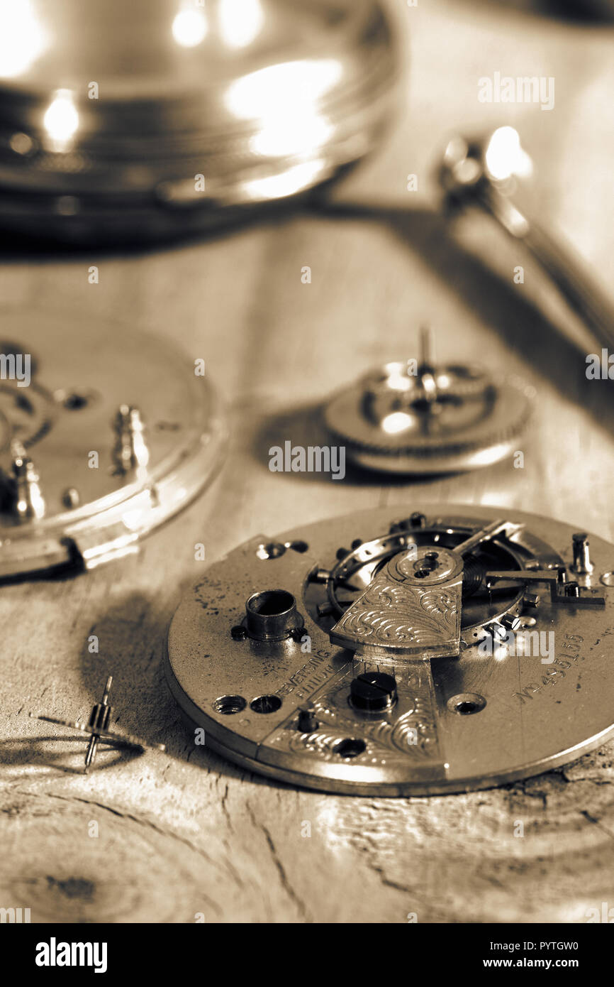 Parts and mechanism from an old antique pocket fob watch on a wood ...