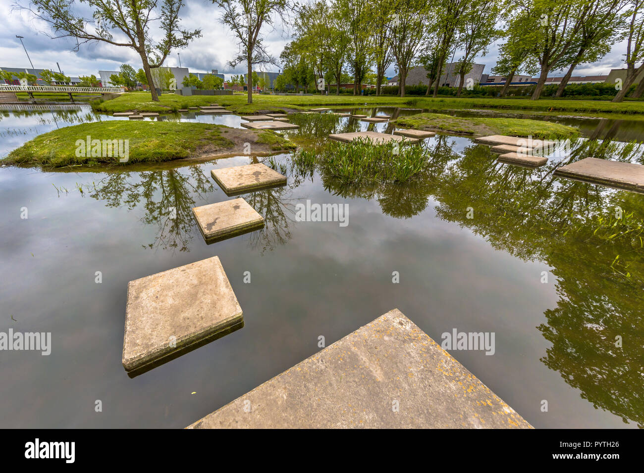 Stepping stones in pond of public park as part of playground for ...