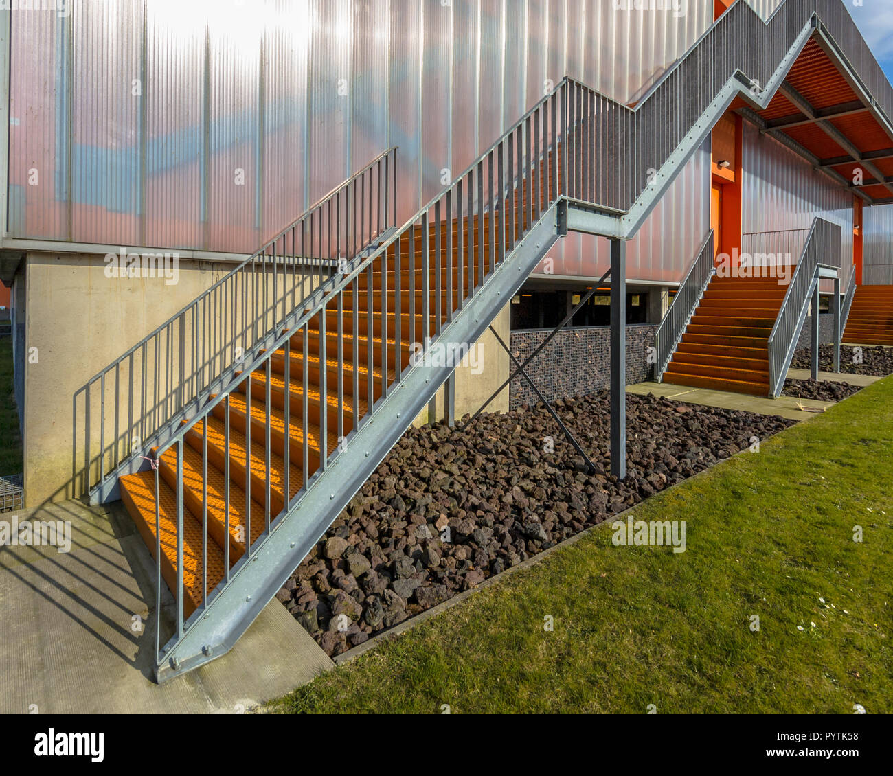 Metal emergency exit escape ladder on the exterior of a building facade ...