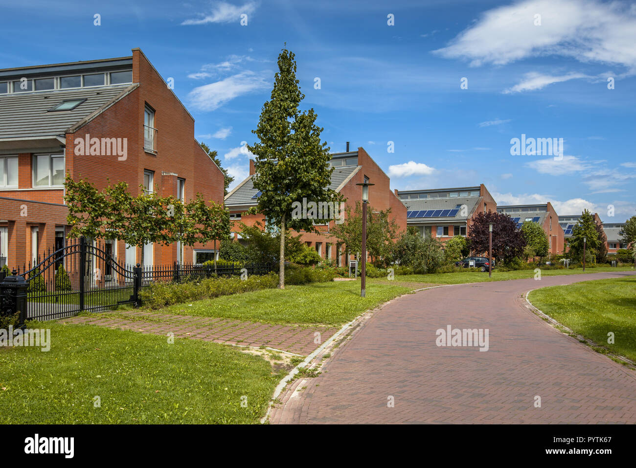 Street with large detached middle class family houses in a suburb of ...
