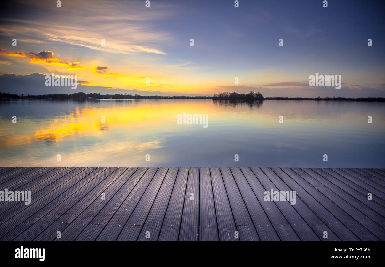 Wooden recreational swimming deck on the lakeside during spectacular ...