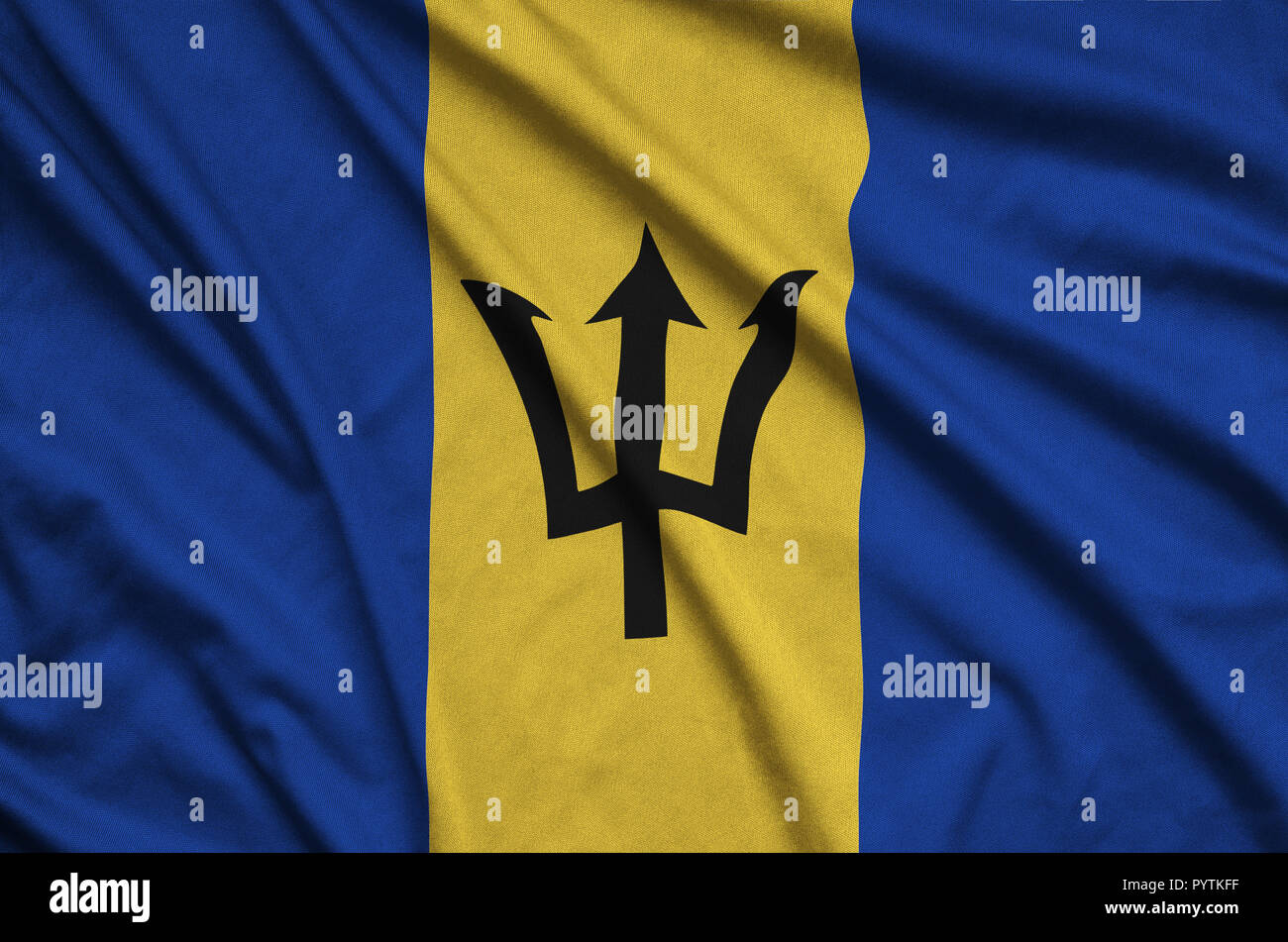 Barbados flag is depicted on a sports cloth fabric with many folds ...
