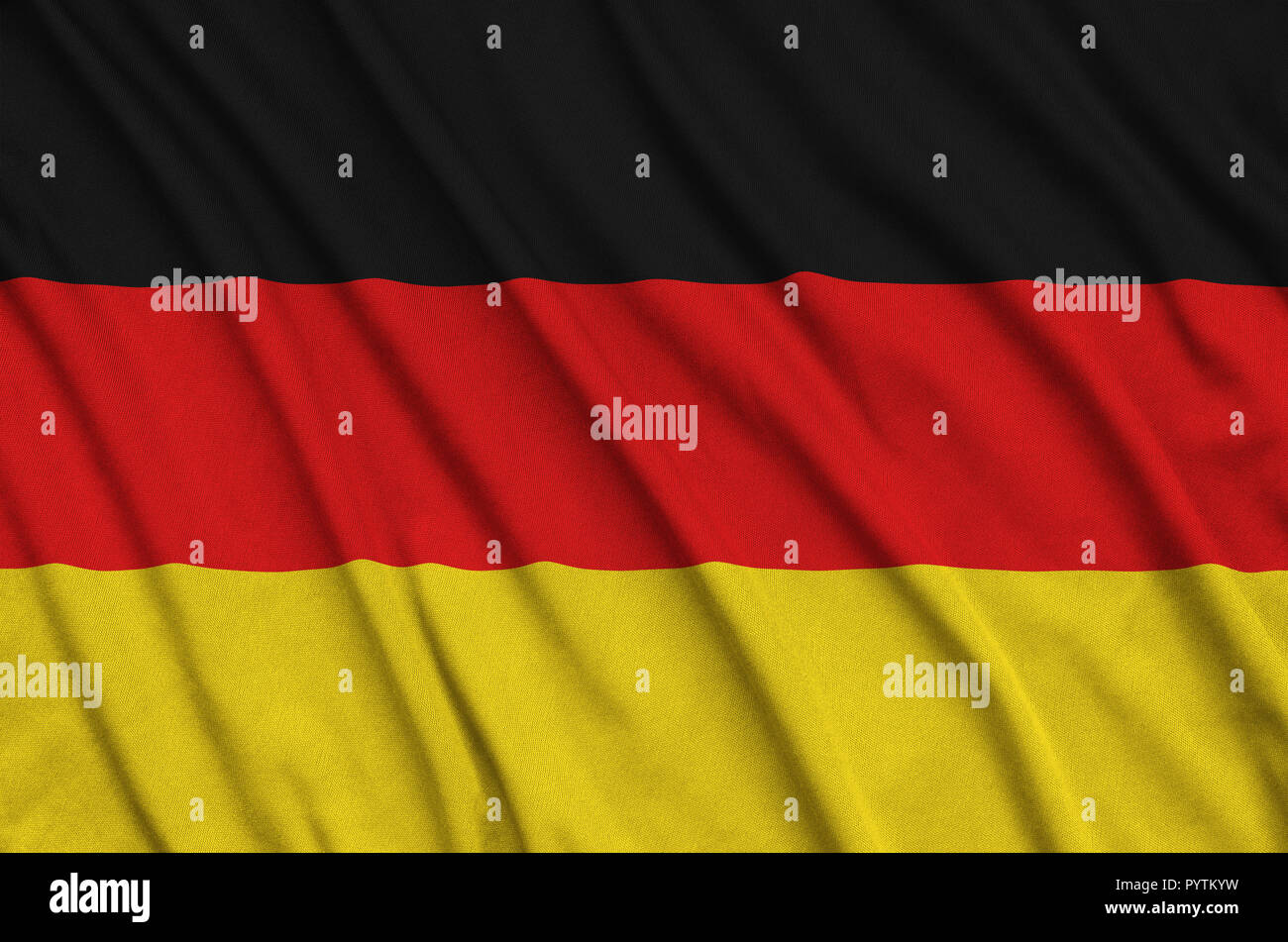 Germany flag is depicted on a sports cloth fabric with many folds ...