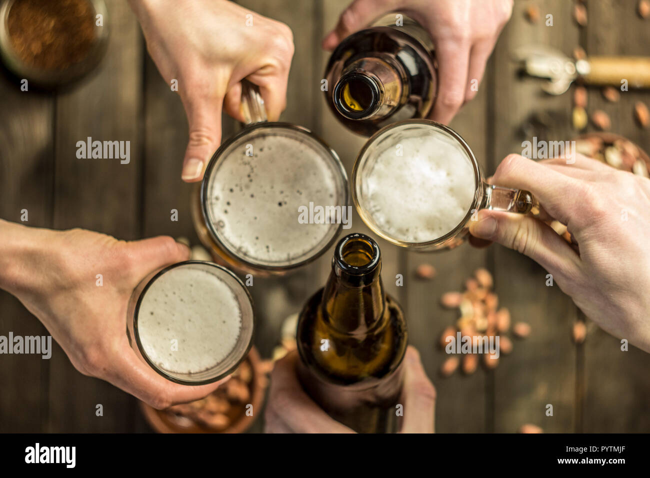 A group of friends holding beer mugs Stock Photo - Alamy