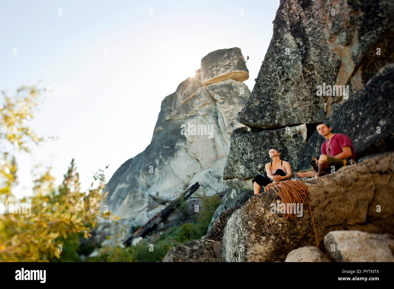 Two rock climbers sitting on the rock Stock Photo - Alamy