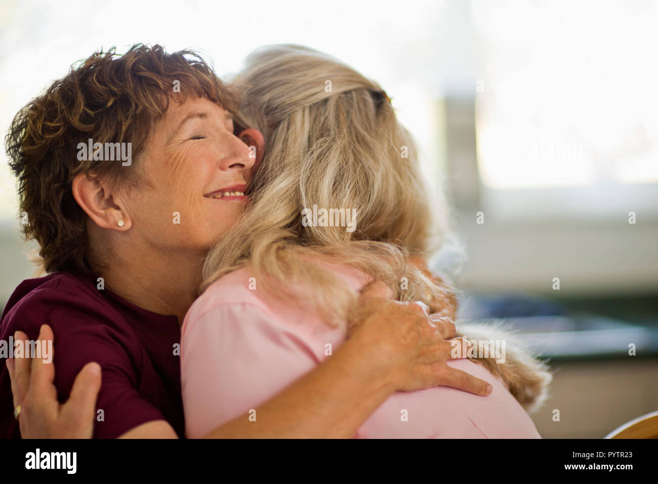 Smiling nurse hugging a relieved patient Stock Photo - Alamy