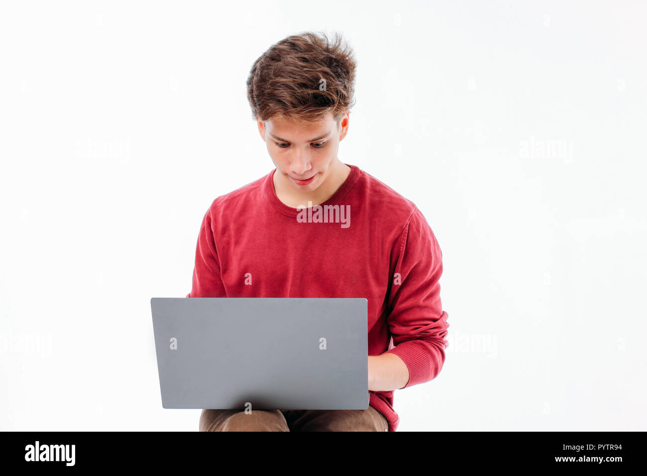 Teenager student working at laptop on white background Stock Photo - Alamy