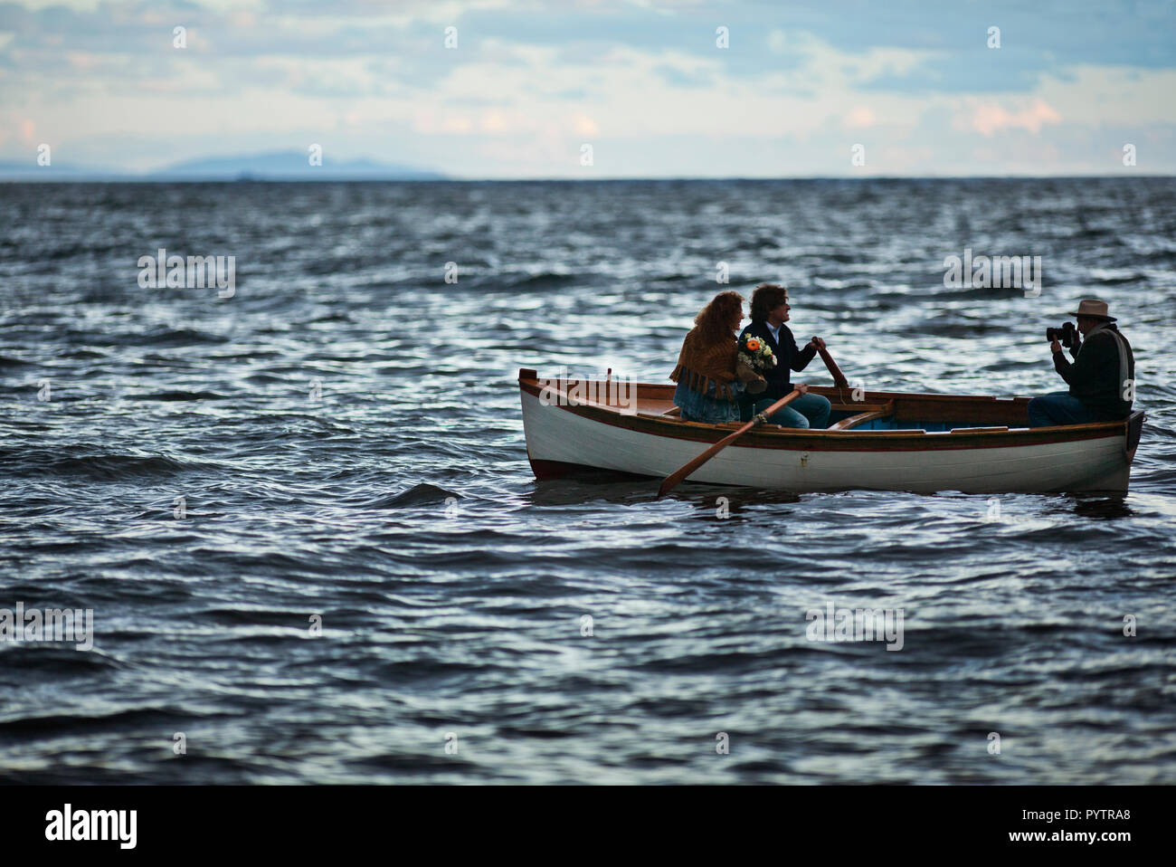 Couple being photographed on a row boat Stock Photo - Alamy