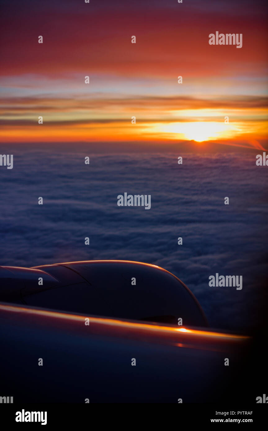 Sunrise from an airplane above the clouds Stock Photo - Alamy