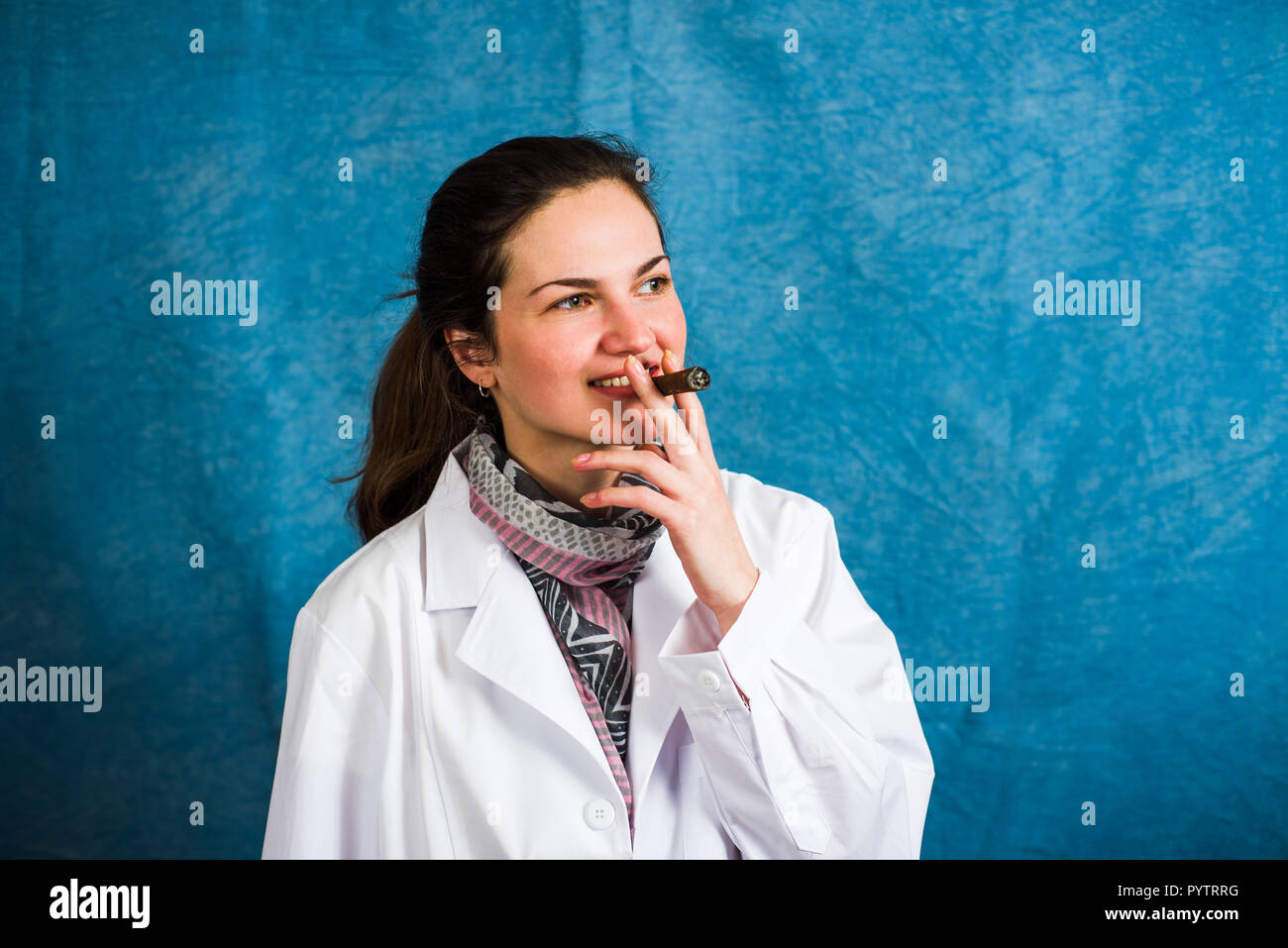 Female doctor smoking a cigarette and enjoying unhealthy lifestyle ...
