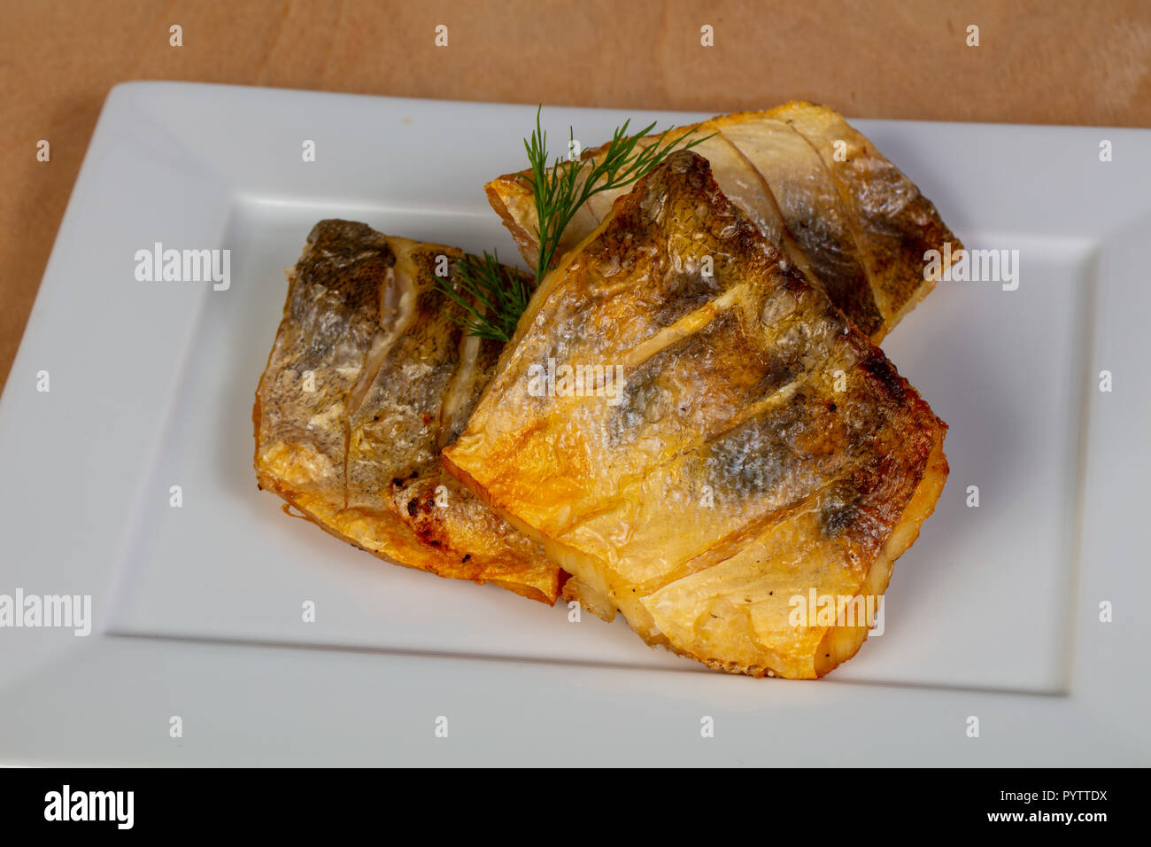 Roasted pike perch in the plate Stock Photo - Alamy