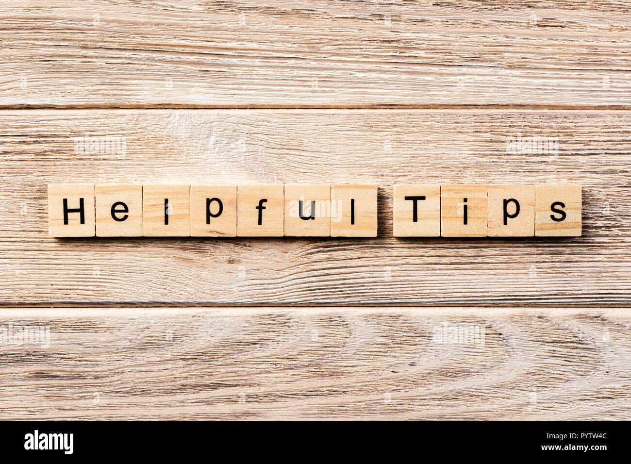 helpful tips word written on wood block. helpful tips text on table ...