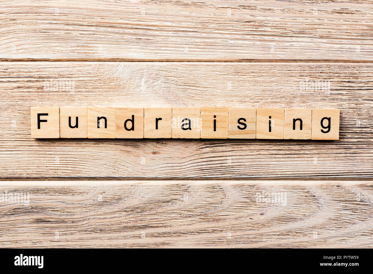 fundraising word written on wood block. fundraising text on table ...