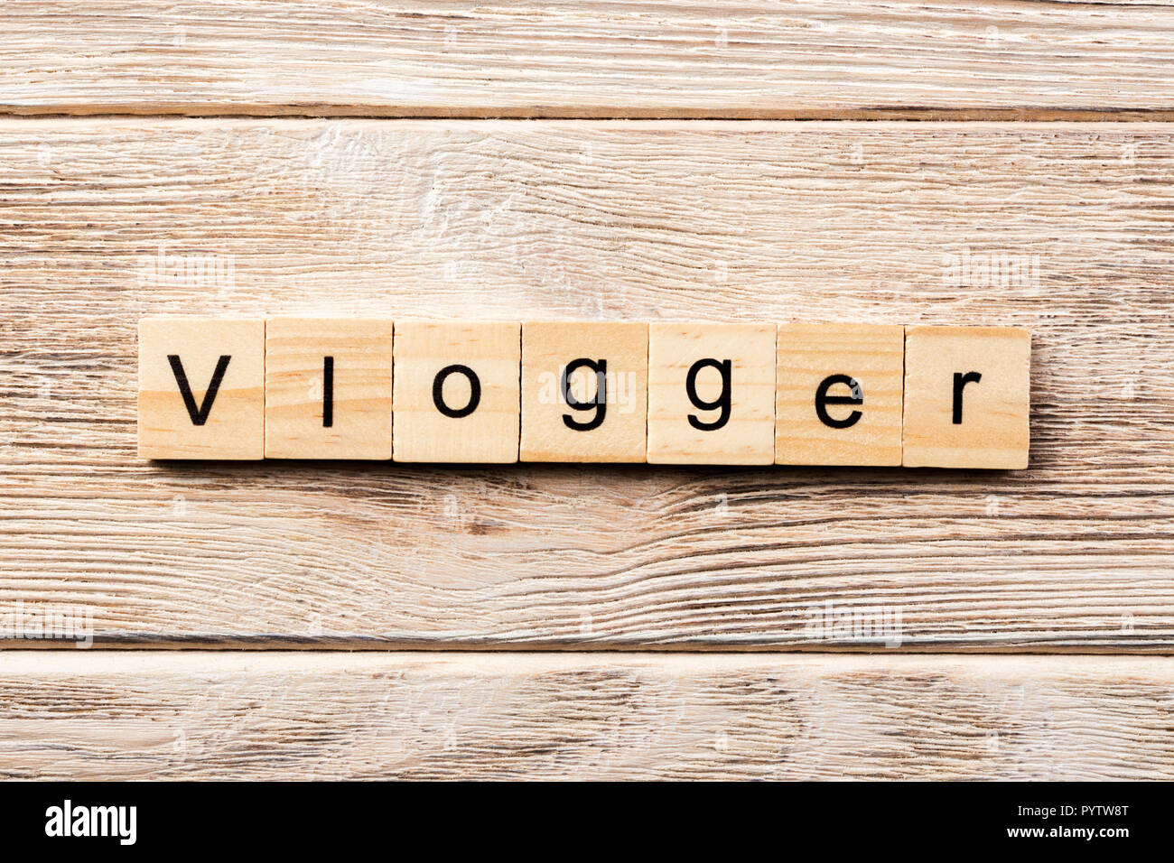 vlogger word written on wood block. vlogger text on table, concept ...