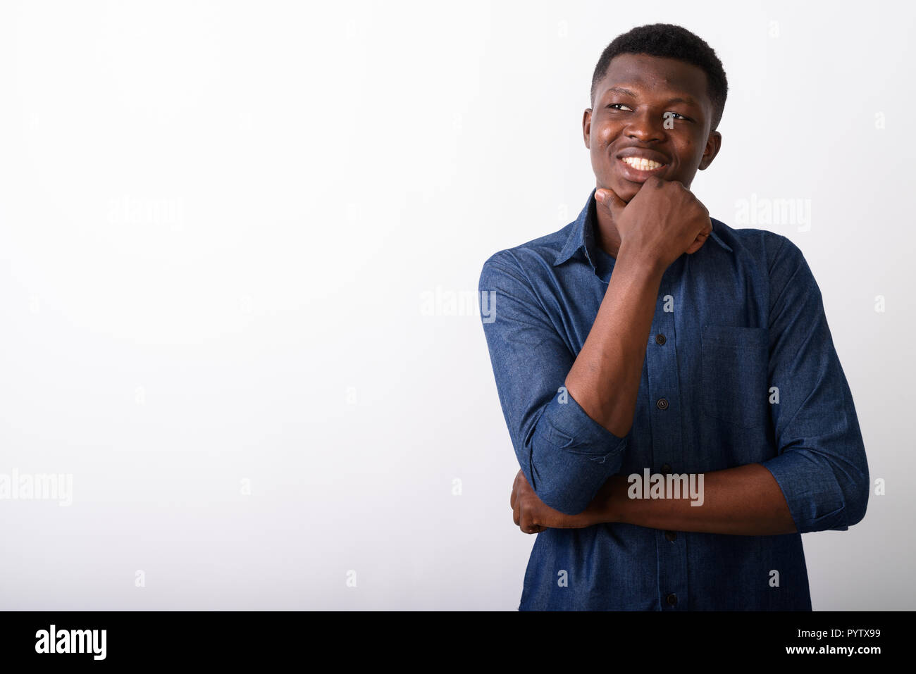 Studio shot of young happy black African man smiling while think Stock ...