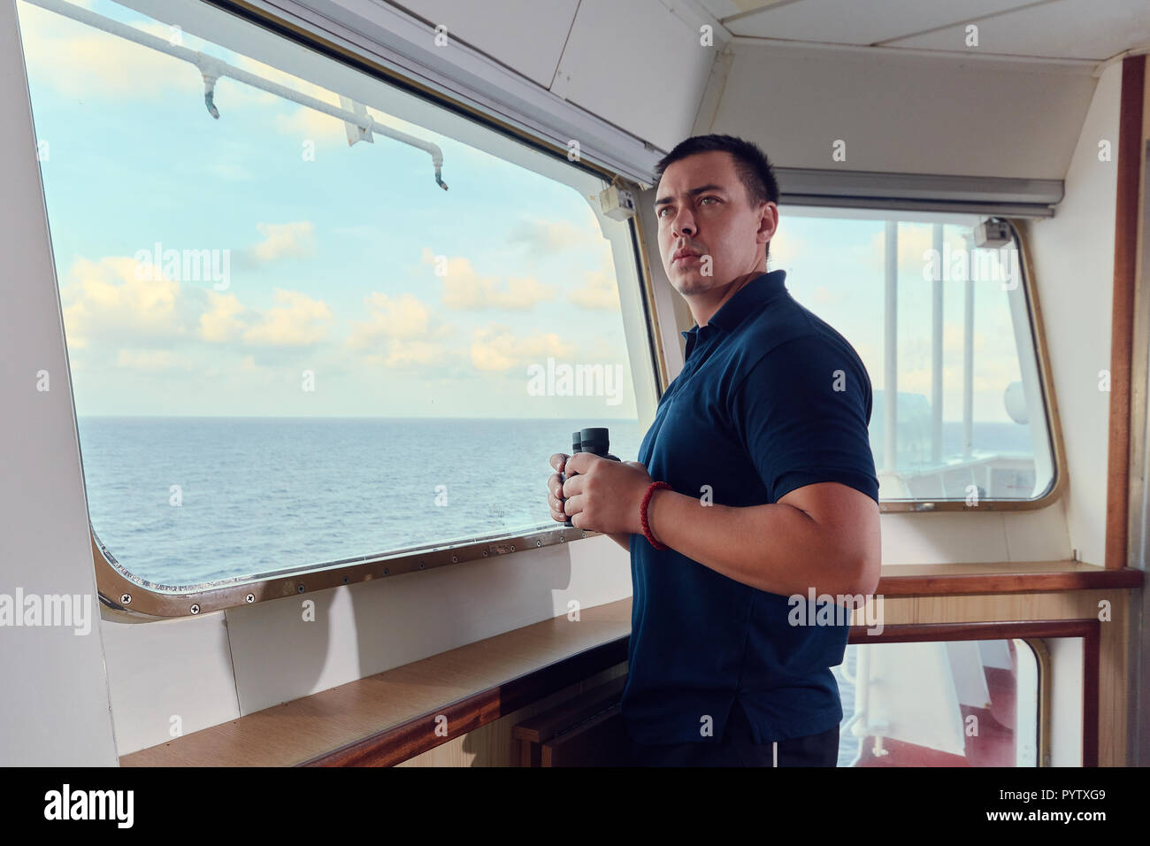 Navigation offcier / Pilot on the bridge of a ship underway with ...