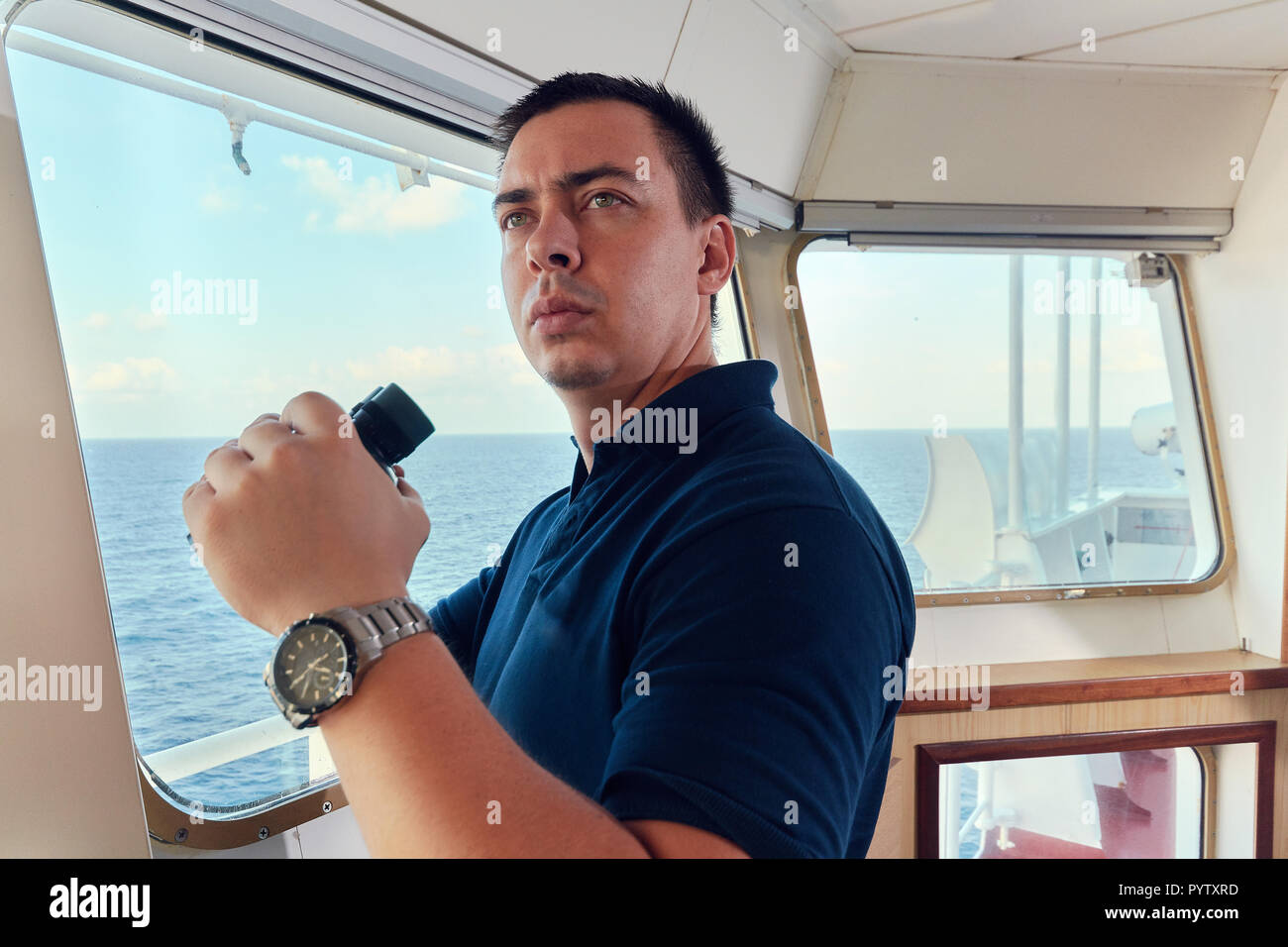 Navigation offcier / Pilot on the bridge of a ship underway with ...