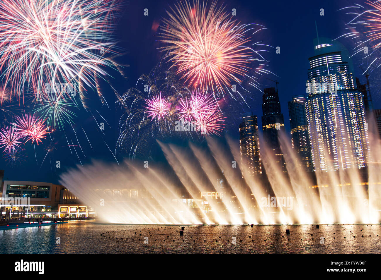 Fireworks over Dubai mall fountain show at night Stock Photo - Alamy