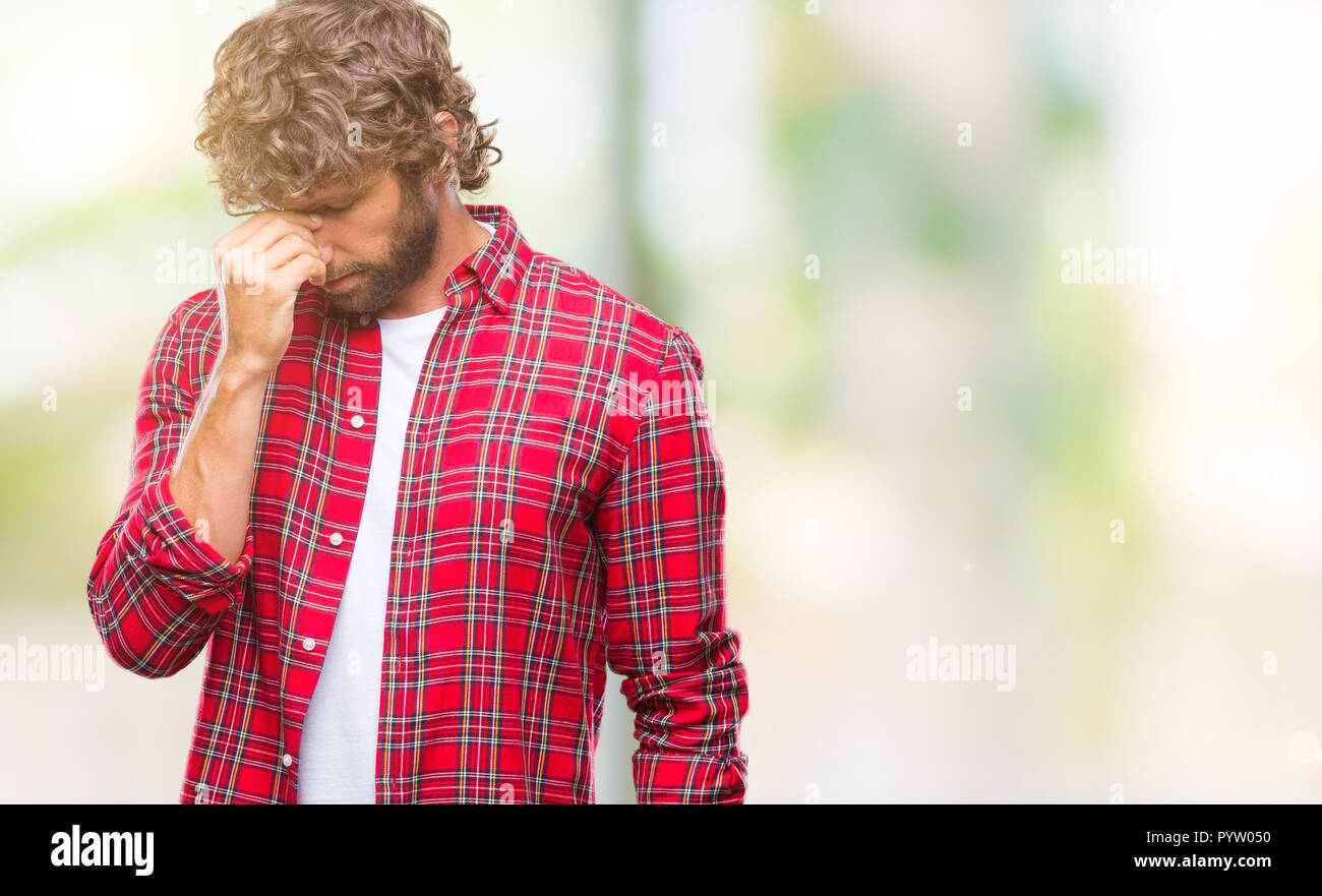 Handsome hispanic model man over isolated background tired rubbing nose ...
