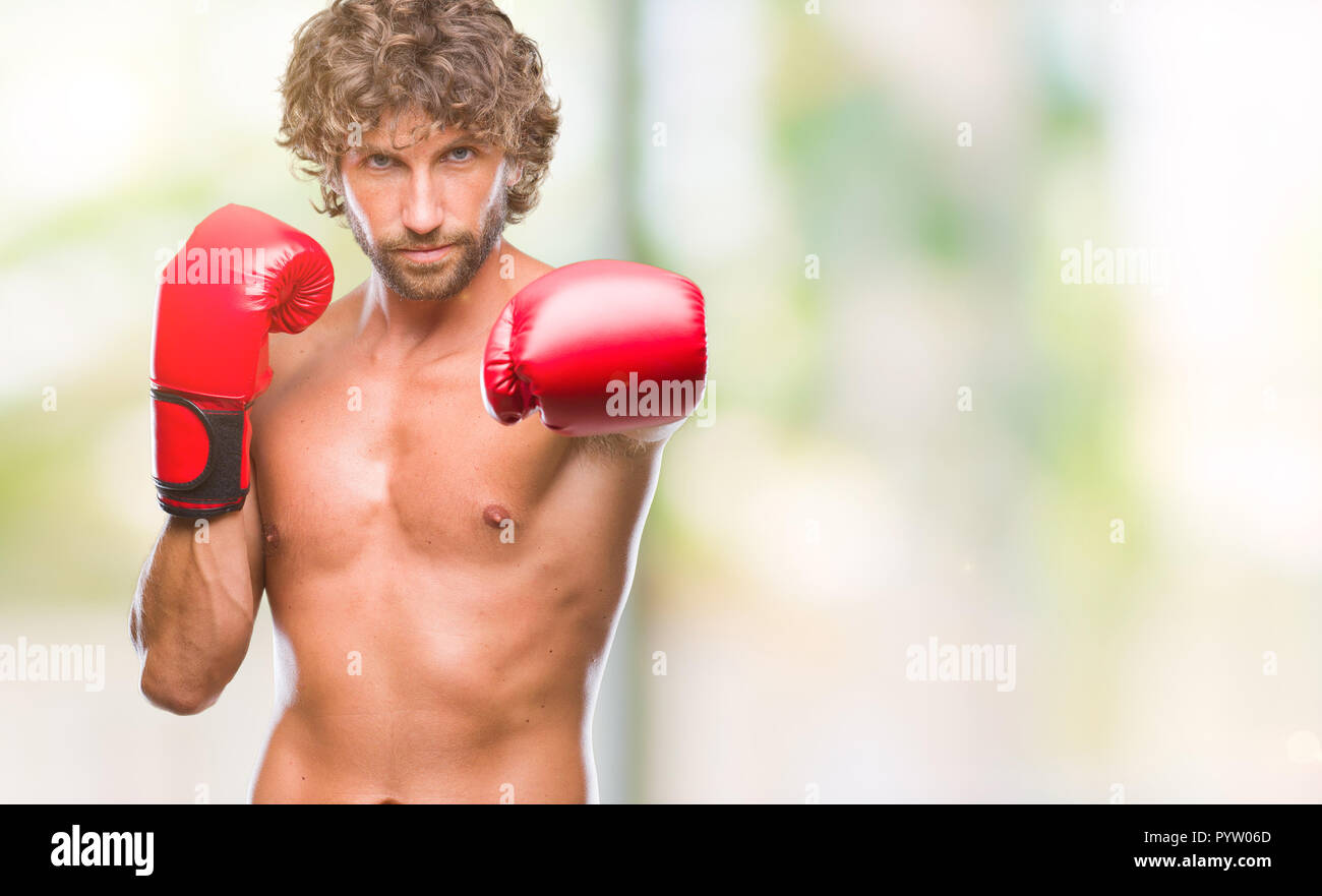 Handsome hispanic boxer man wearing boxing gloves over isolated ...