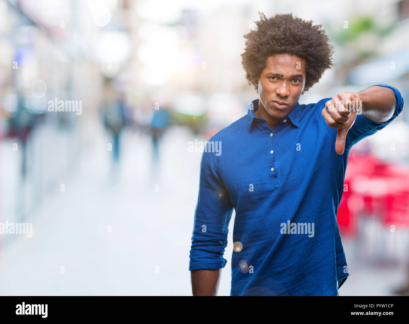 Afro american man over isolated background looking unhappy and angry ...