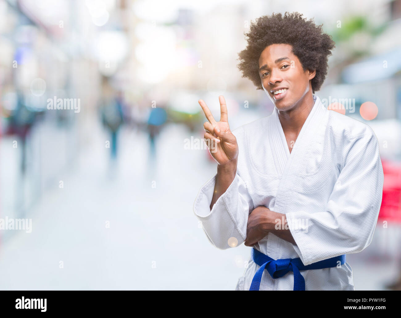 Afro american man wearing karate kimono over isolated background ...