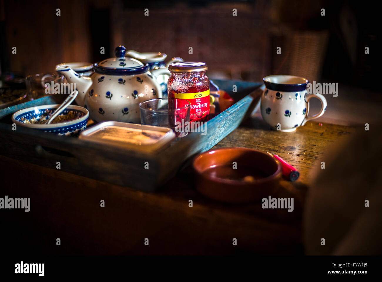 British tea time. domestic scene , tea tray laid with mugs teapot ...