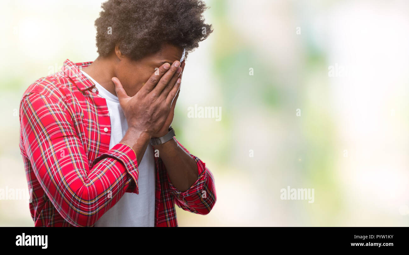 Afro american man over isolated background with sad expression covering ...