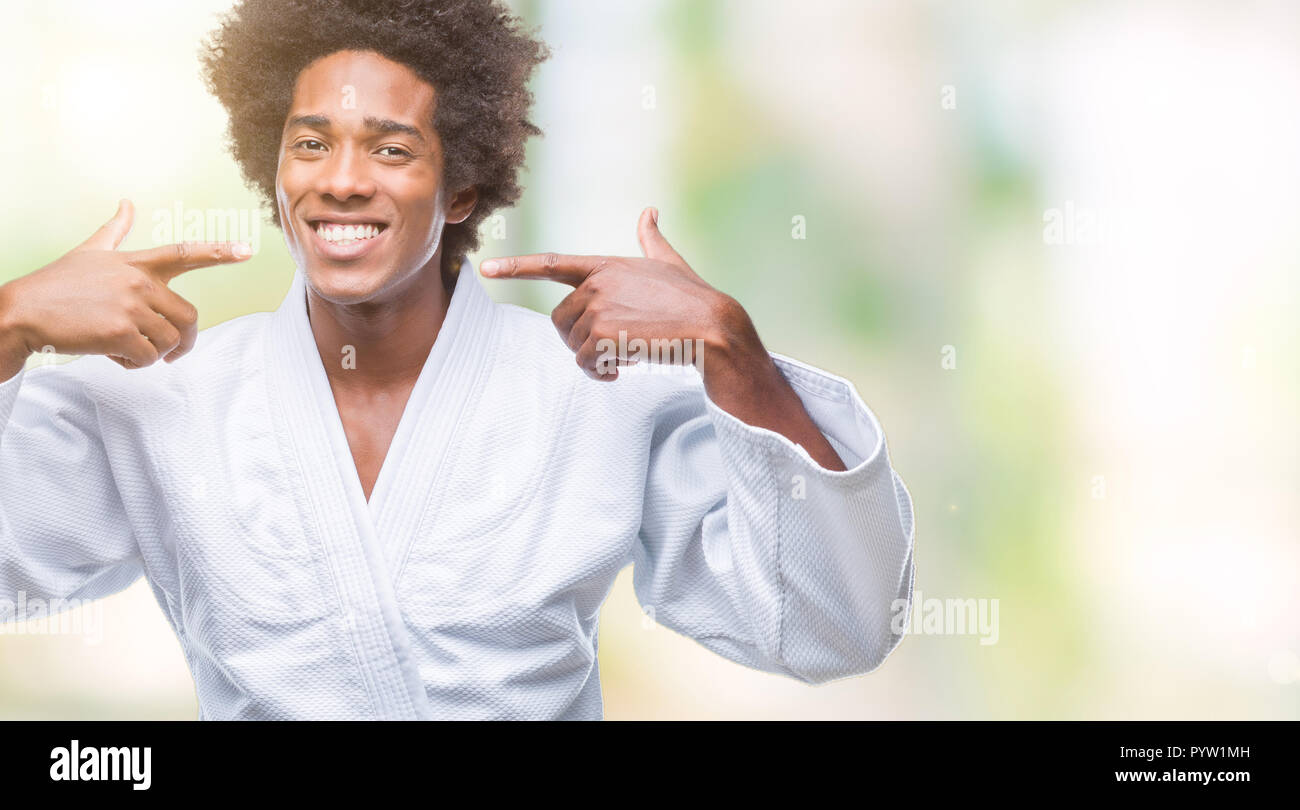 Afro american man wearing karate kimono over isolated background ...