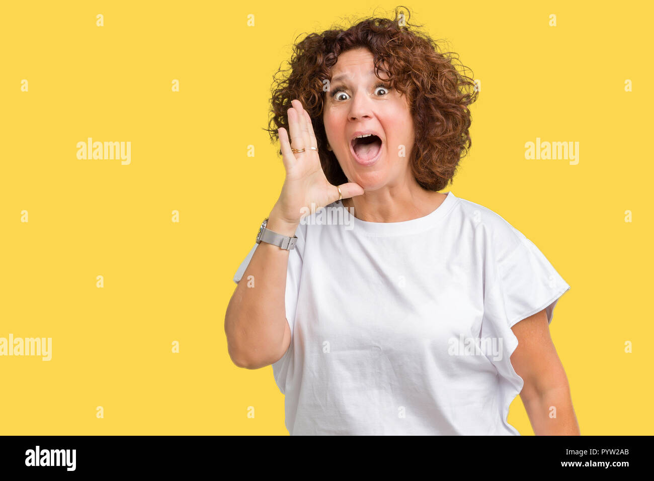 Beautiful middle ager senior woman wearing white t-shirt over isolated ...