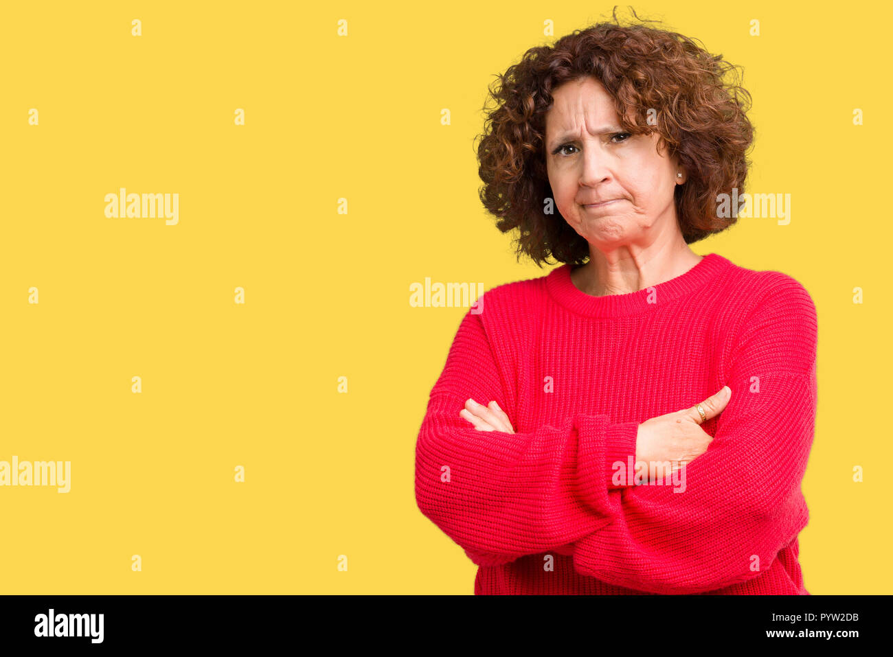 Beautiful middle ager senior woman red winter sweater over isolated ...