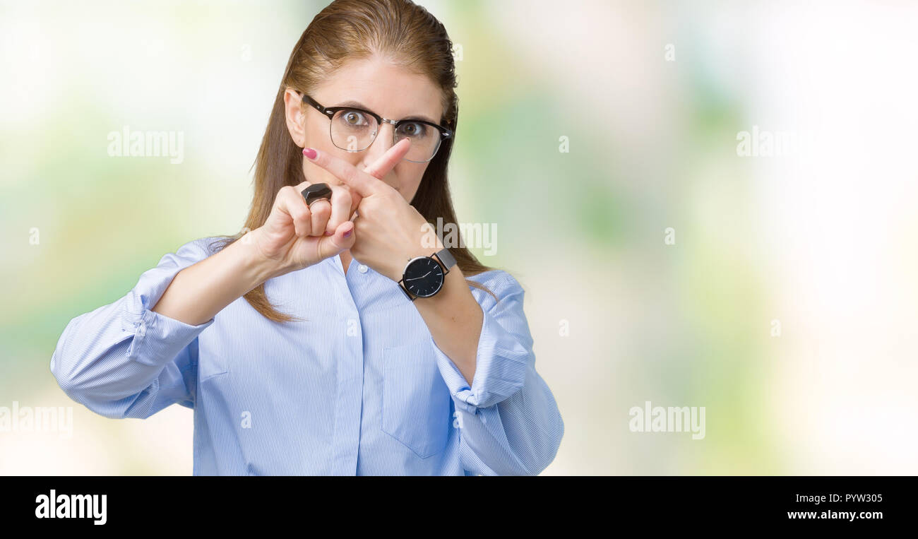 Beautiful middle age mature business woman wearing glasses over ...