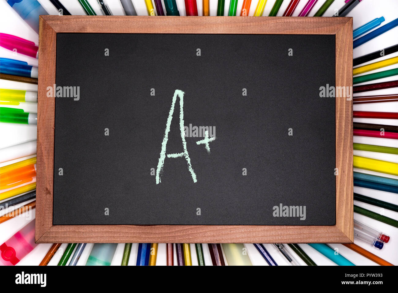 Education concept. A with plus or perfect mark written on blackboard ...