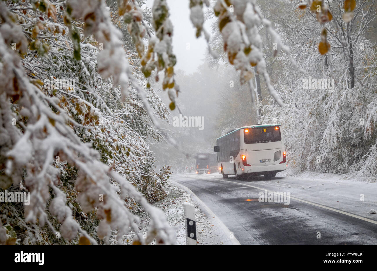 Schmitten, Germany. 30th Oct, 2018. A bus and a truck drive through the ...