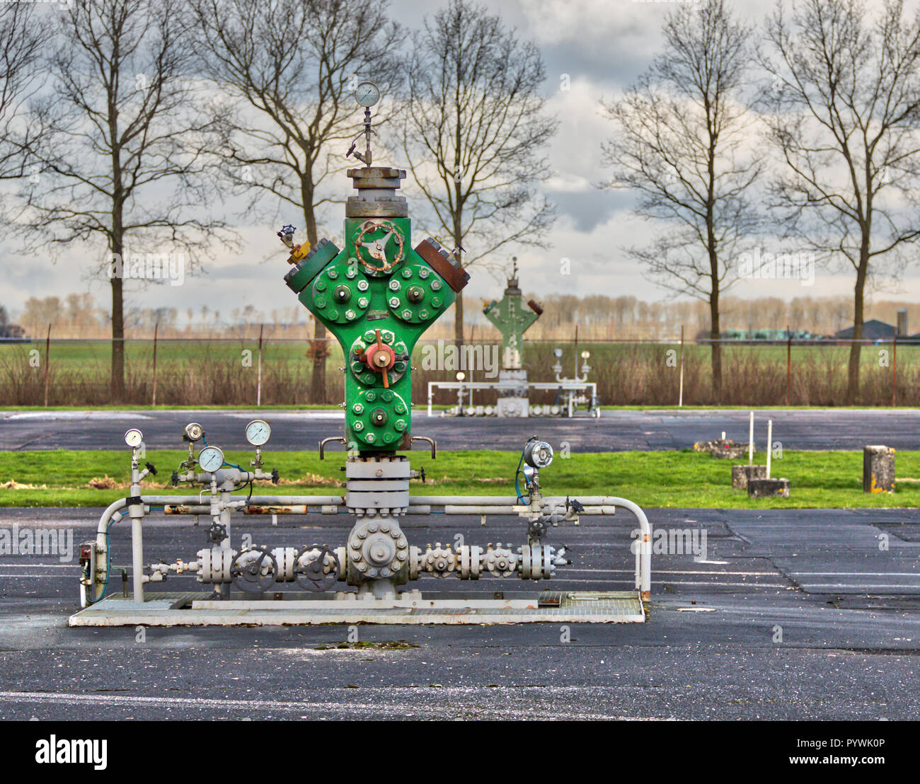 Old wellhead in working natural gas field processing site in northern ...