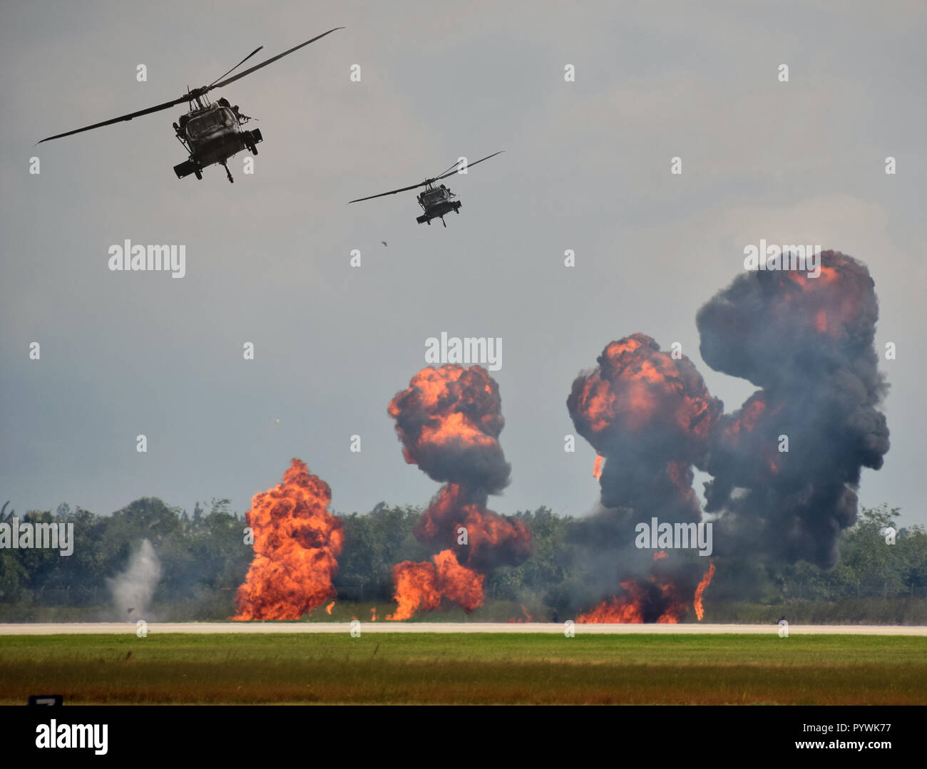 Military helicopters in ground attack with explosions Stock Photo - Alamy