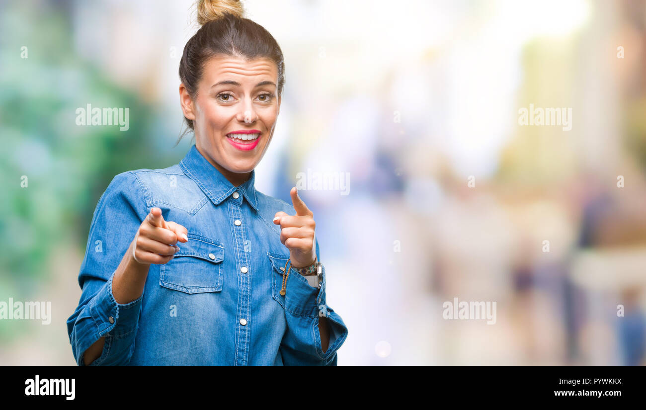 Young beautiful woman over isolated background pointing fingers to ...