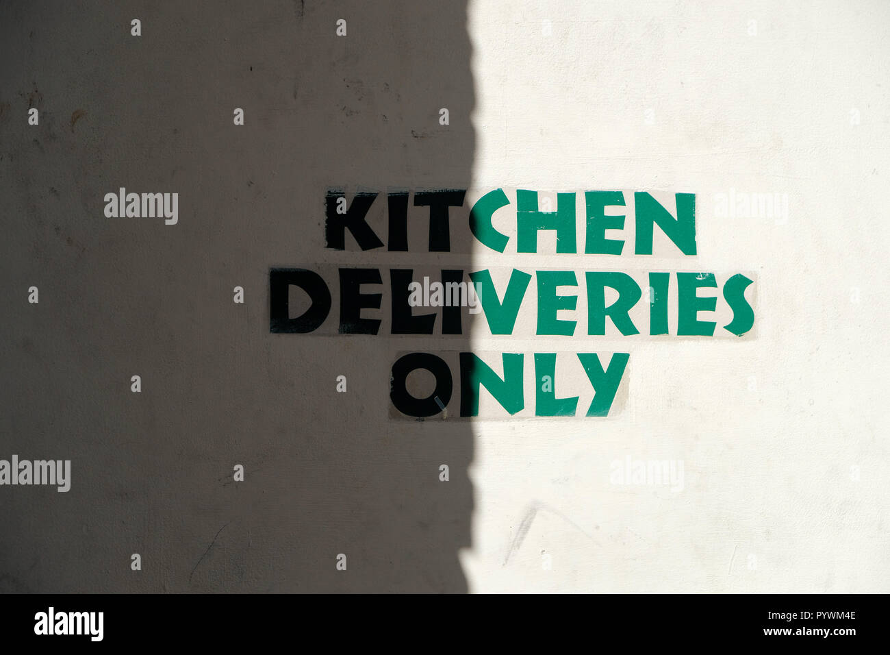 "Kitchen Deliveries Only" wording on a door in an alley behind a ...
