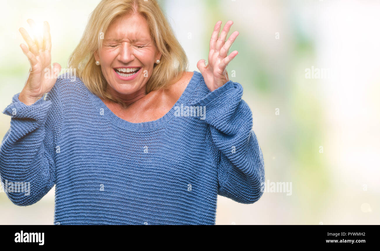 Middle age blonde woman wearing winter sweater over isolated background ...