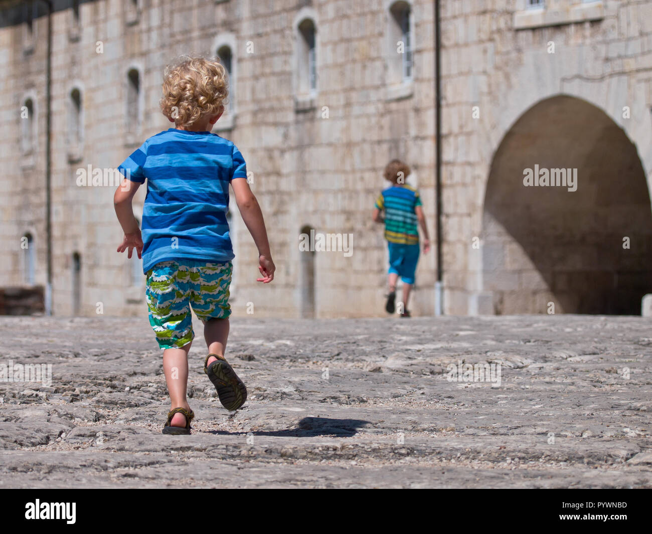 Little Boy Following his Brother to the Entrance of a Tunnel Stock ...