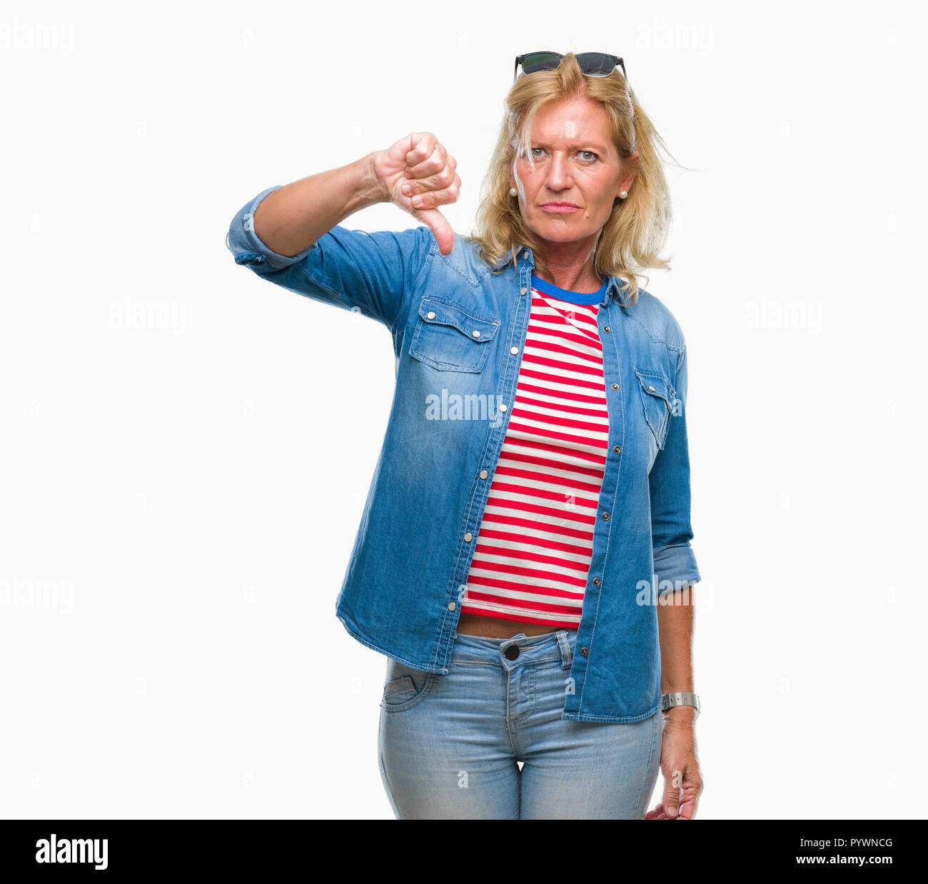 Middle age blonde woman over isolated background looking unhappy and ...