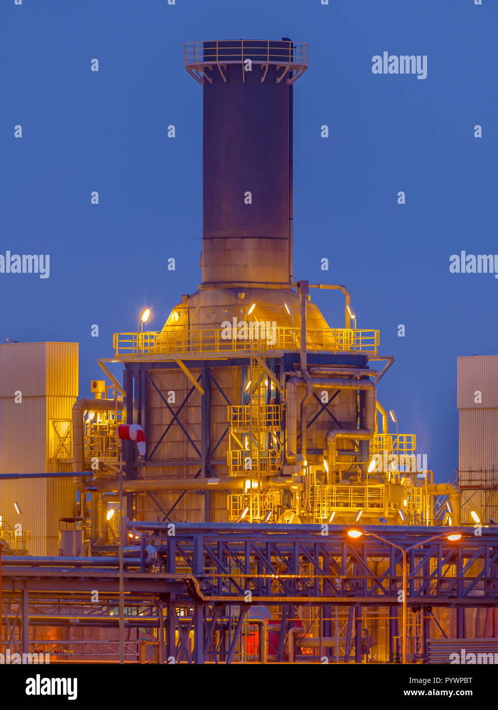 Chemical reactor with chimney on a plant in an industrial factory area ...