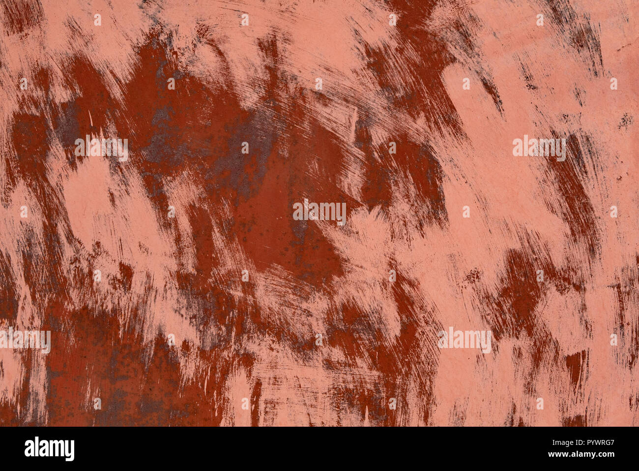 rusty metal surface painted with red color with brush strokes. close up ...
