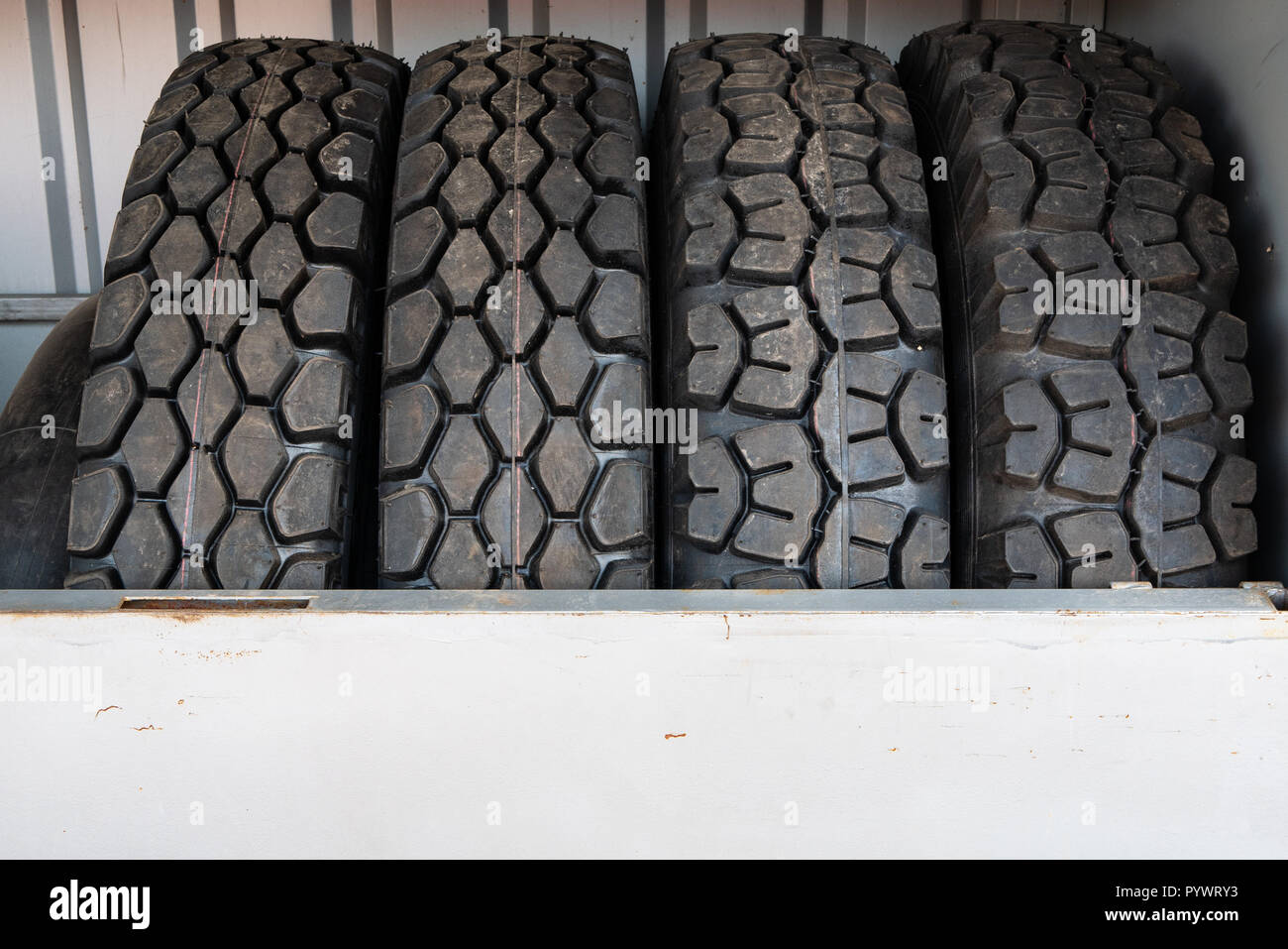 four new big black wheel tyres for sale in vehicle store warehouse ...